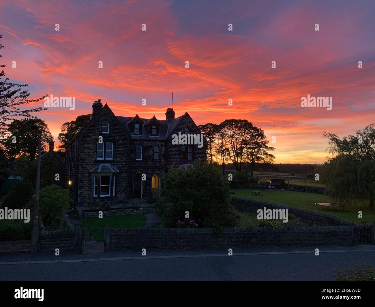Sun setting over a traditional British neighbourhood warm colours to ...