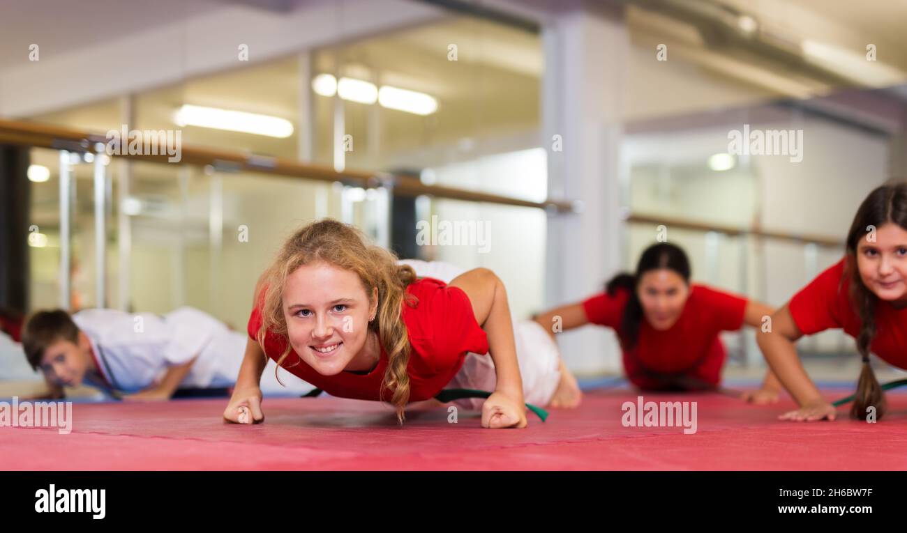 Preteen girl doing push-ups Stock Photo - Alamy