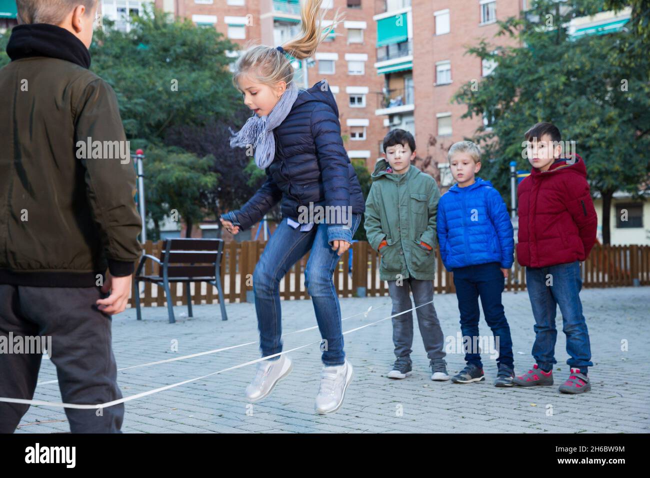Children playing chinese jump rope Stock Photo - Alamy