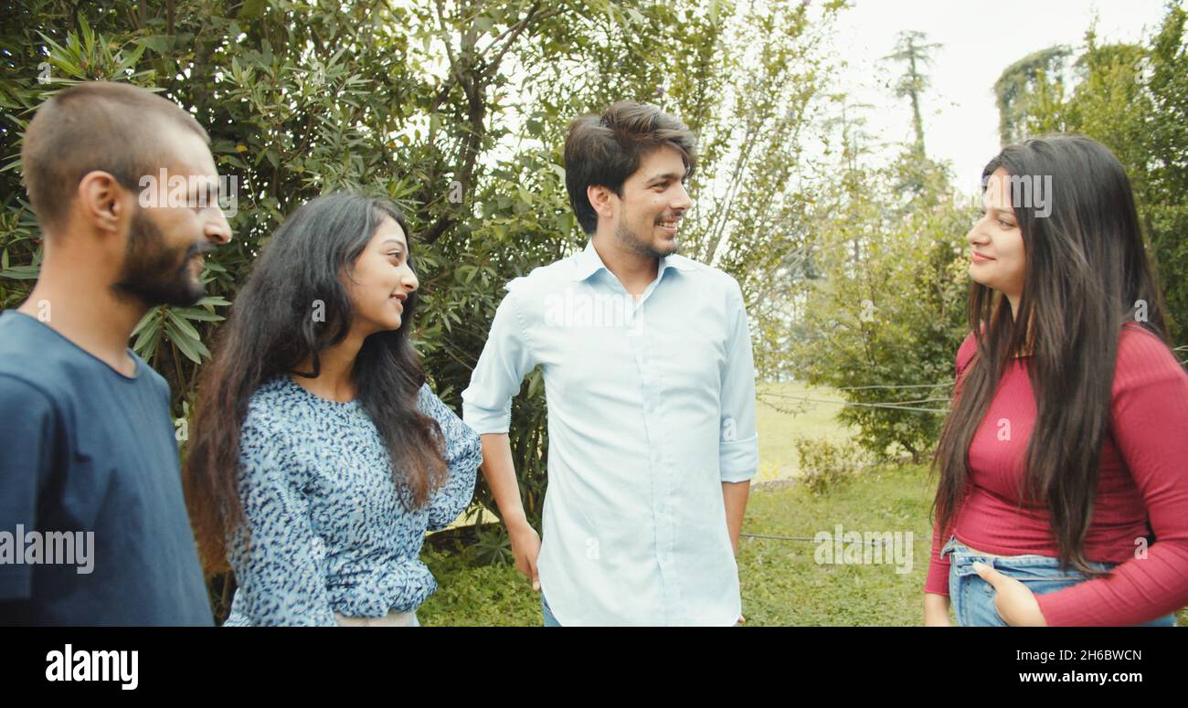 A group of young Indian friends talking in a park Stock Photo - Alamy