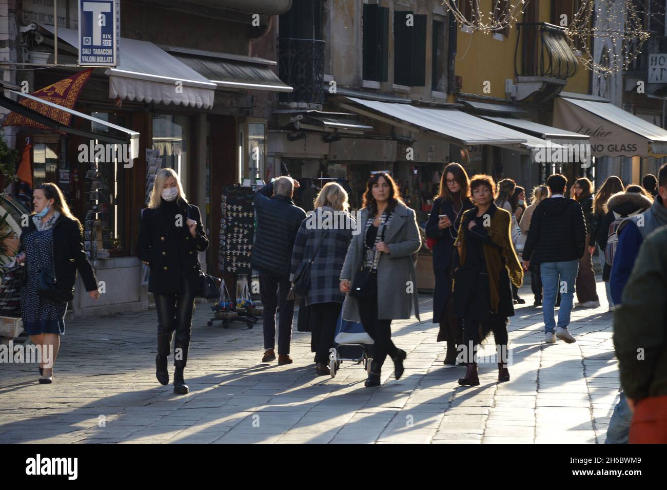 Pedestrians walk on busy street in Cannaregio district in the historic ...