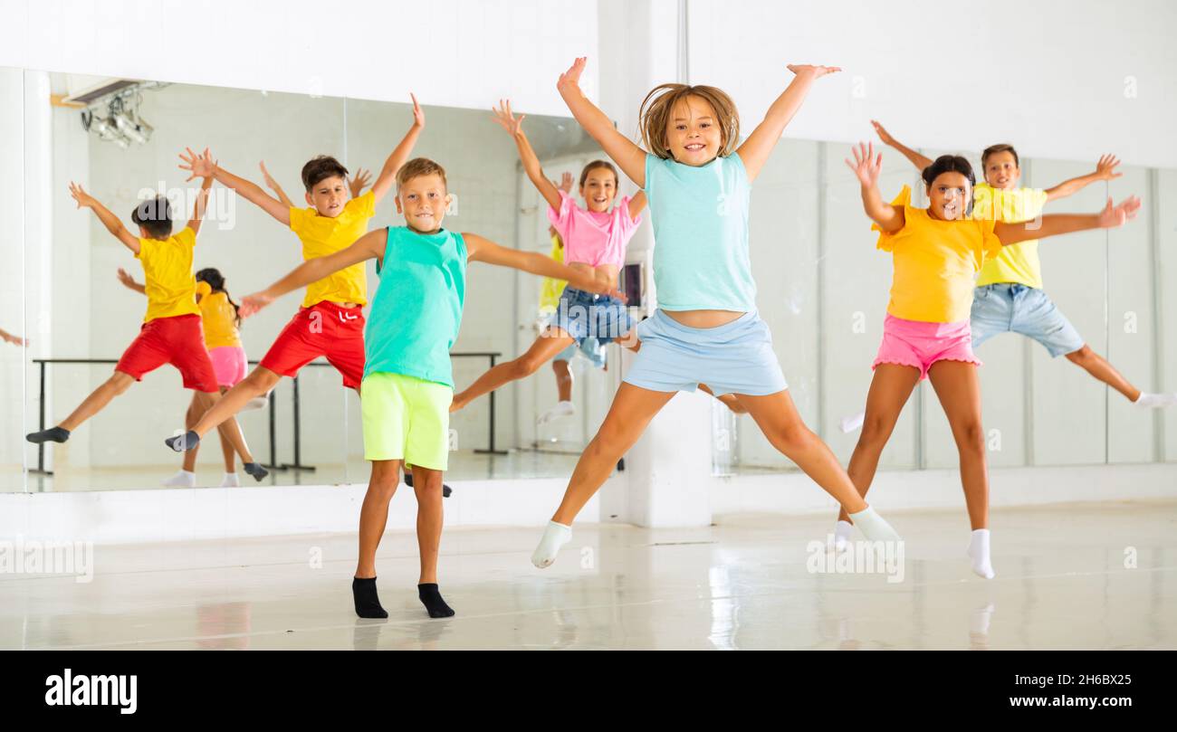 Group of cheerful tweens jumping during dances class Stock Photo - Alamy