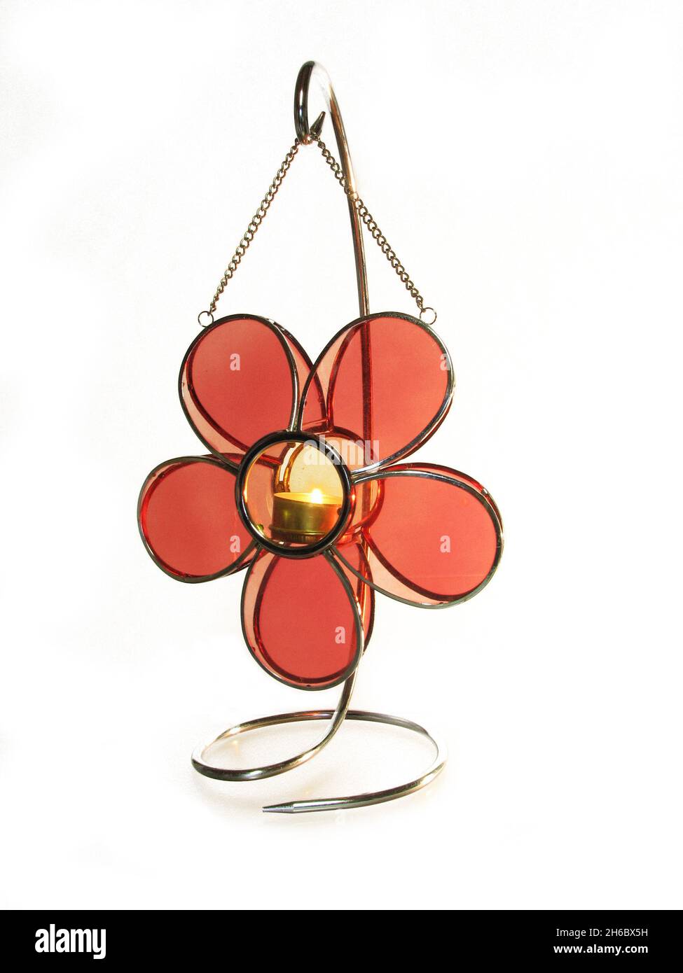 A lamp with the shape of a flower and a candle inside isolated on a ...