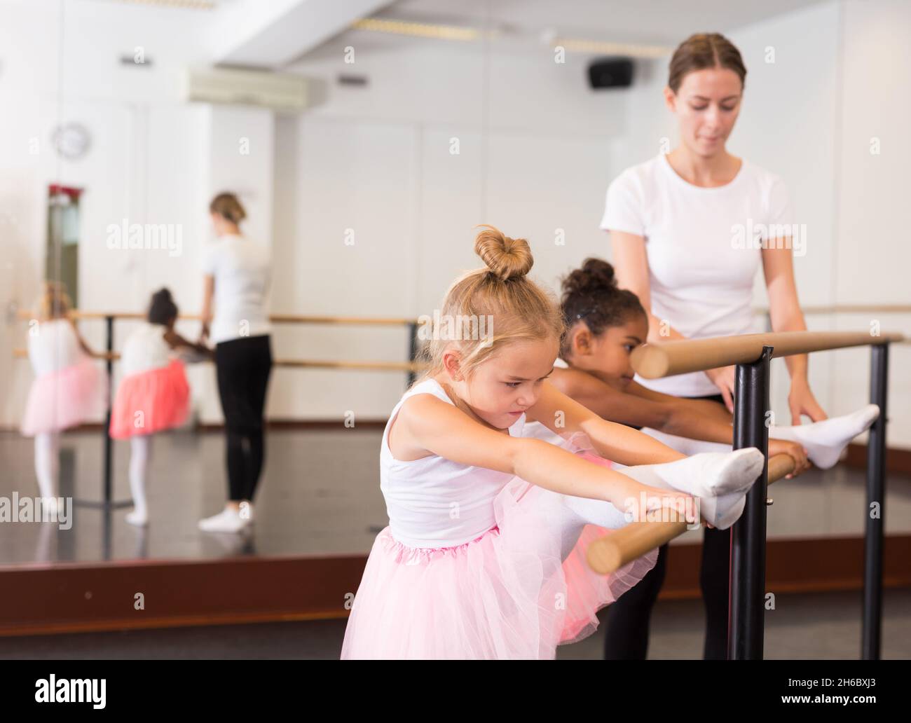 Ballet trainer teaching two little girls Stock Photo - Alamy