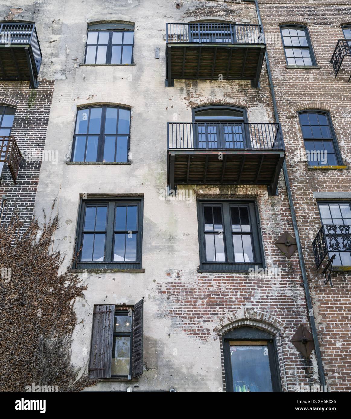 Weathered old building wall of windows Stock Photo - Alamy