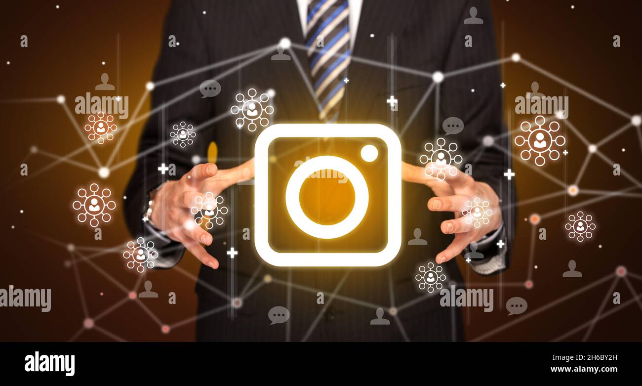 Hand holding social media icons Stock Photo - Alamy