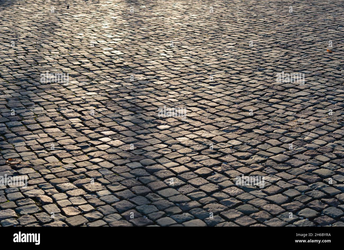 An empty old uneven cobblestone street pavement under sunlight Stock ...