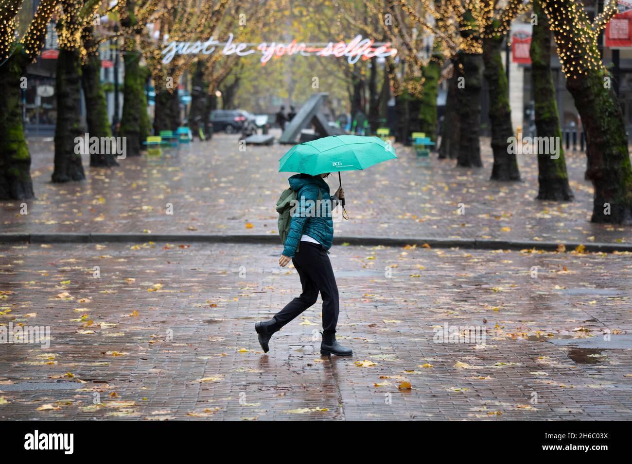A visitor walks through Occidental Square in Seattle on Sunday ...
