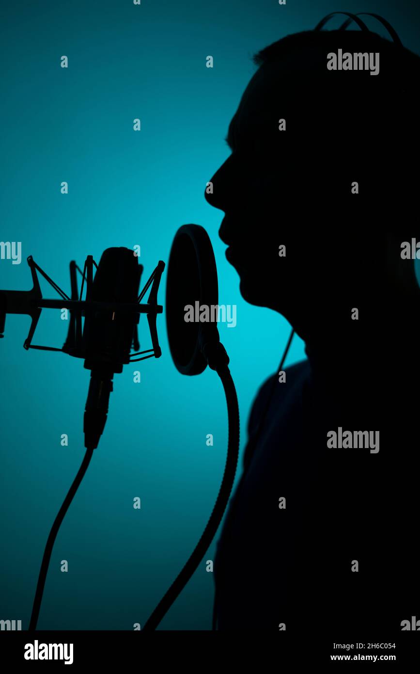 Voiceover artist voice actor in vocal recording studio with larg ...