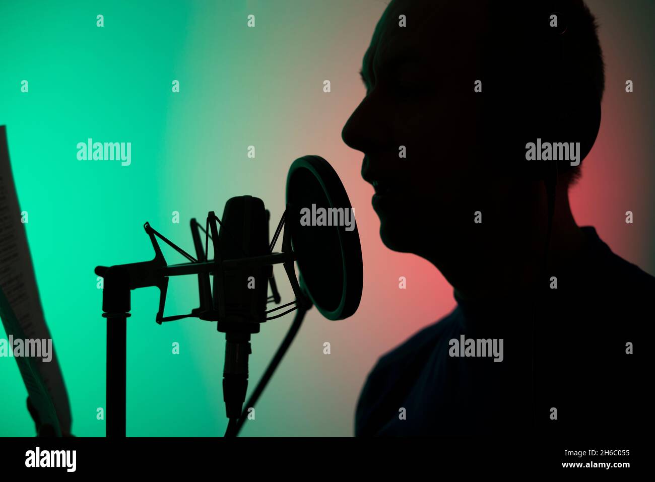 Voiceover artist voice actor in vocal recording studio with larg ...