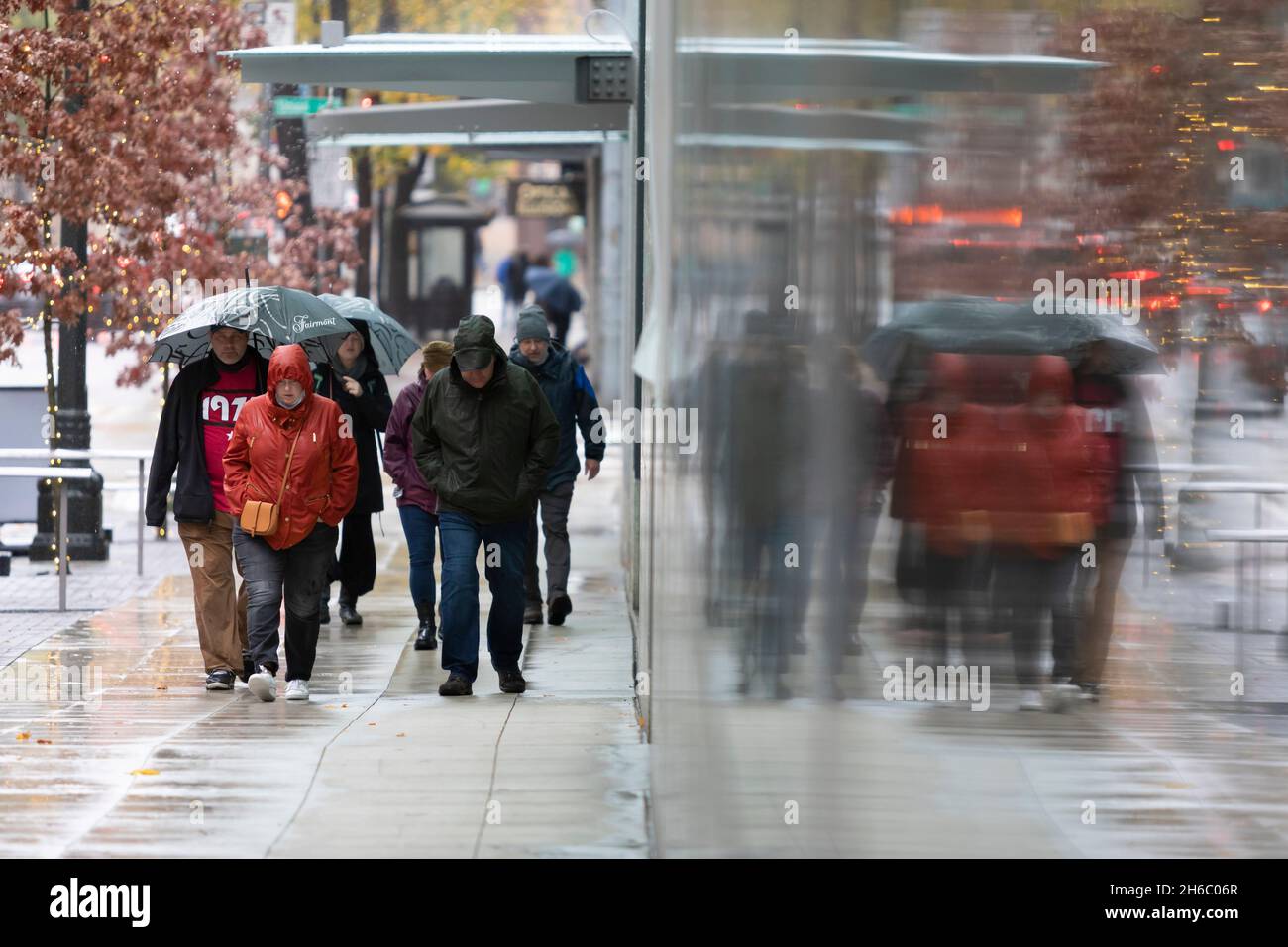 Visitors brave heavy rain and gusty winds in downtown Seattle on Sunday ...