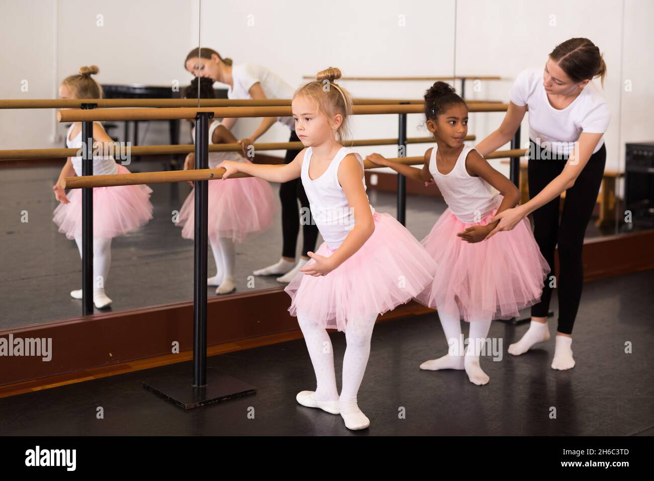 Ballet trainer teaching two little girls Stock Photo - Alamy