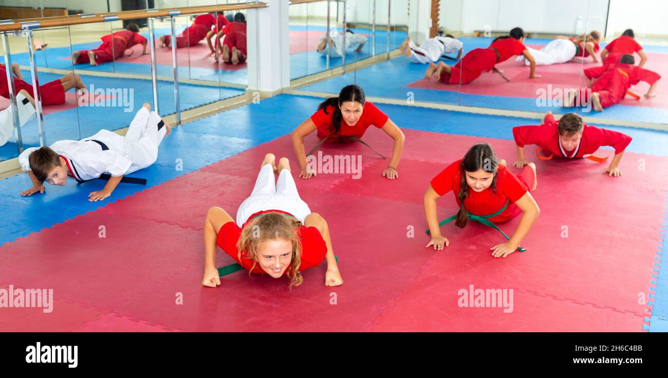 Karate kids doing push-ups in gym Stock Photo - Alamy