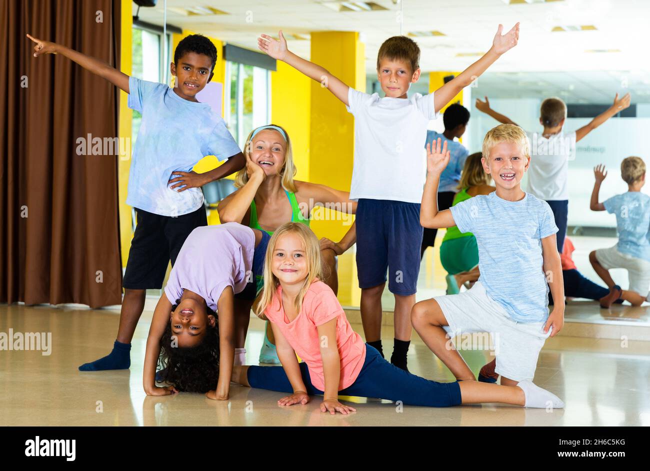 Happy tweens with female coach in dance school Stock Photo - Alamy