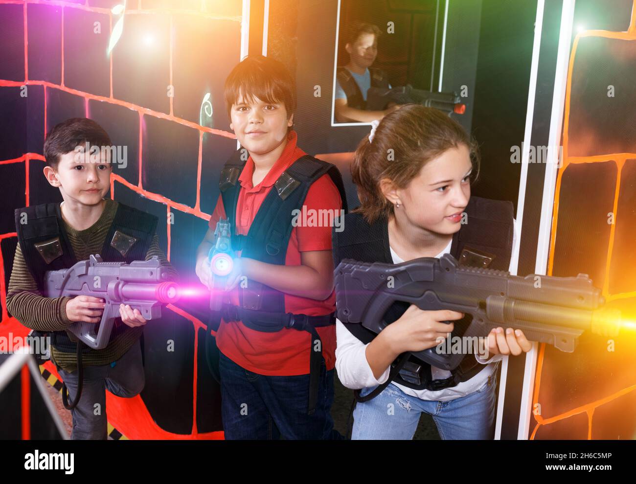 Kids playing laser tag on labyrinth Stock Photo - Alamy