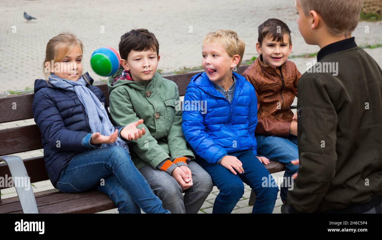 Kids playing ball together on the street Stock Photo - Alamy