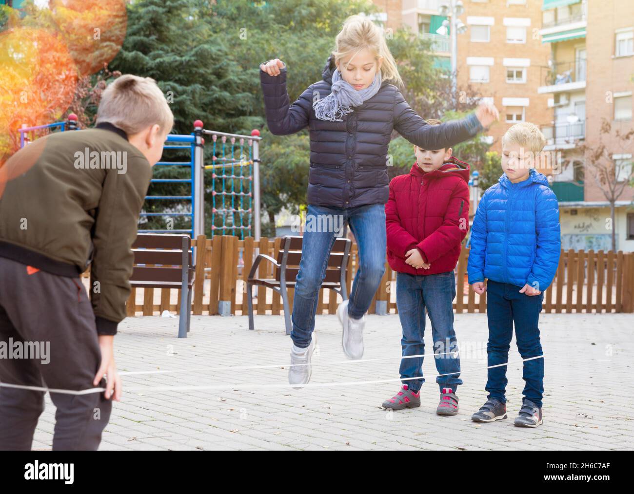 Children playing chinese jump rope Stock Photo - Alamy