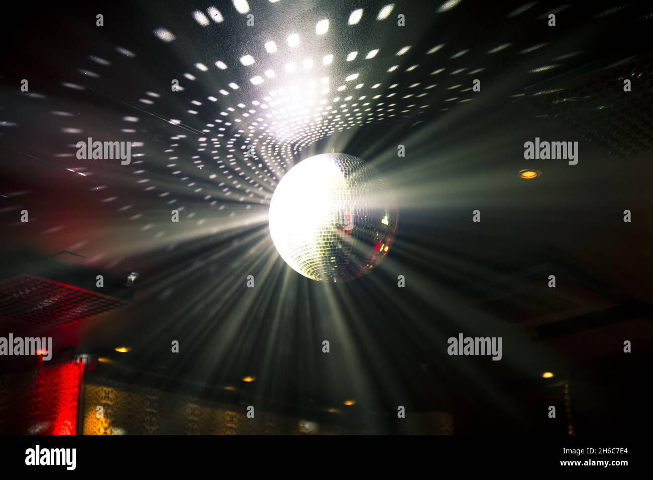 Shining disco ball hanging from the ceiling Stock Photo - Alamy