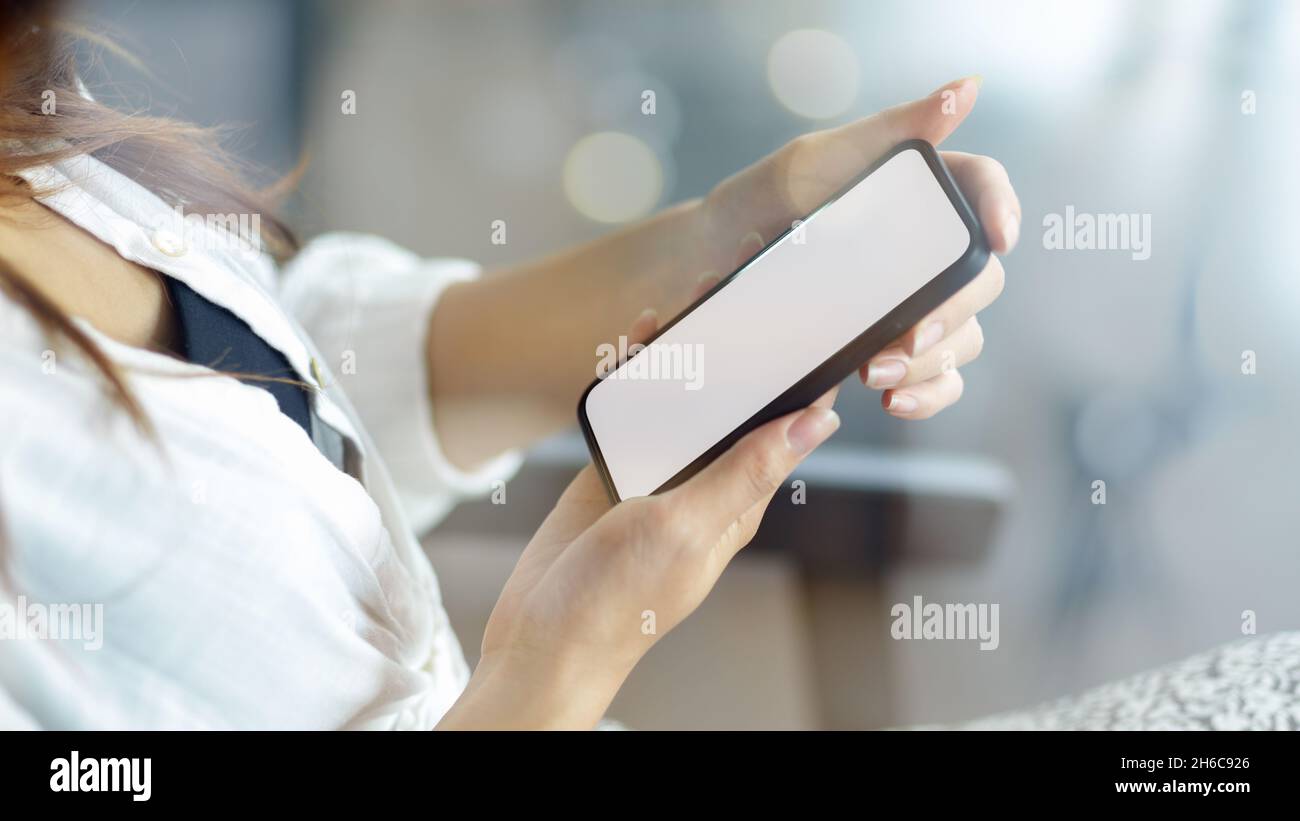 Side view, Woman holding smart phone watching video, shopping, chatting ...