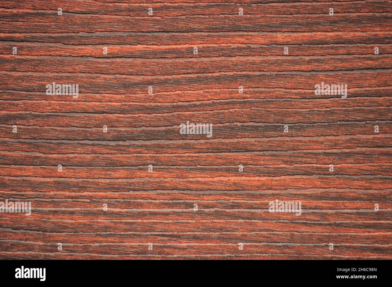 Mahogany polished flat surface of natural red wood with a striped cut ...