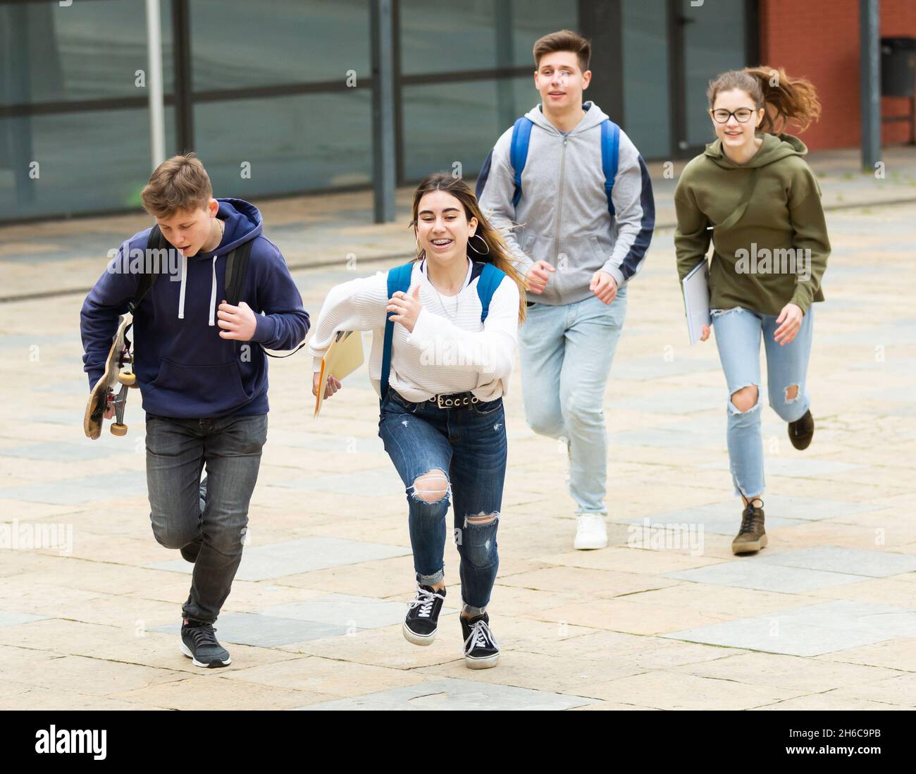 Teenager school kids running Stock Photo - Alamy