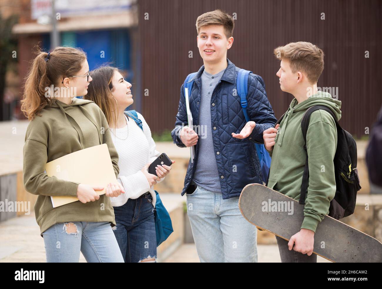 Teenage students talking outside after lessons Stock Photo - Alamy