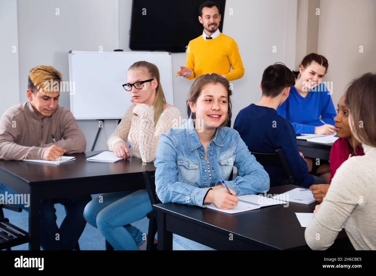 Fellow students having group work tasks during school day Stock Photo ...