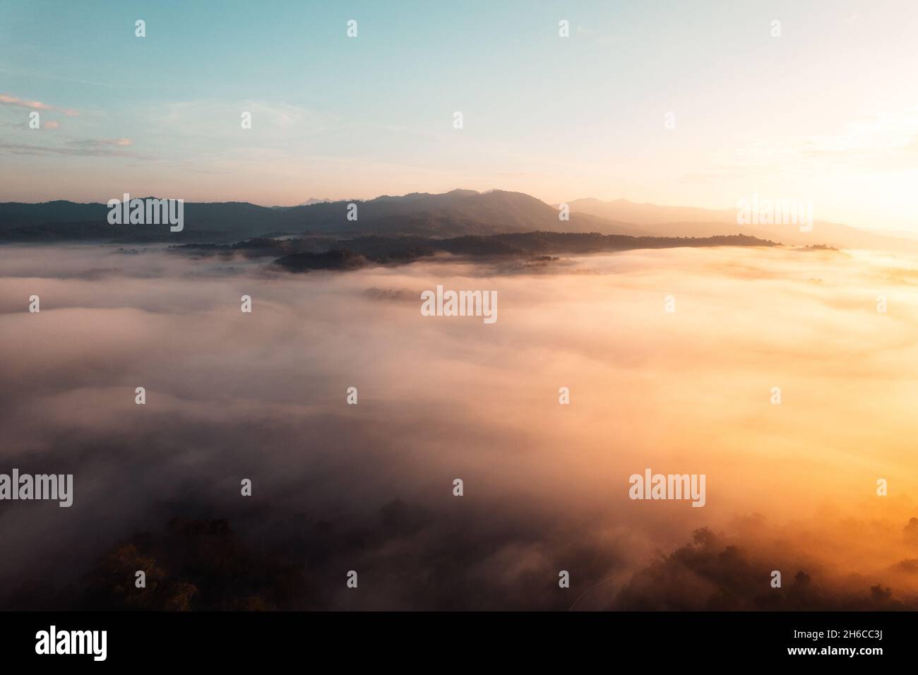Flying above the clouds sunrise and fog,on the hill Stock Photo - Alamy