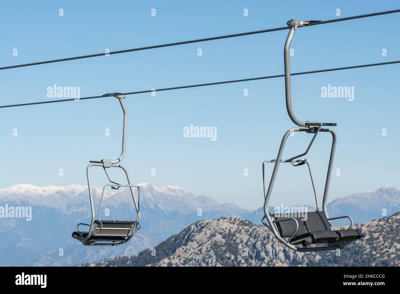 Cable car seats close-up with snow mountains at background Stock Photo ...