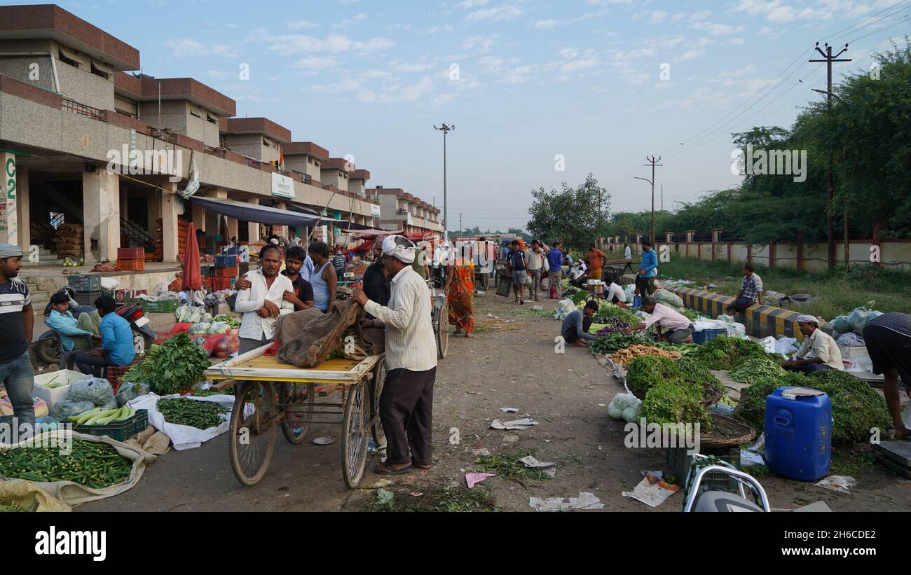 A friendly indian vendor weighing vegetables for a customer hi-res stock photography and images ...