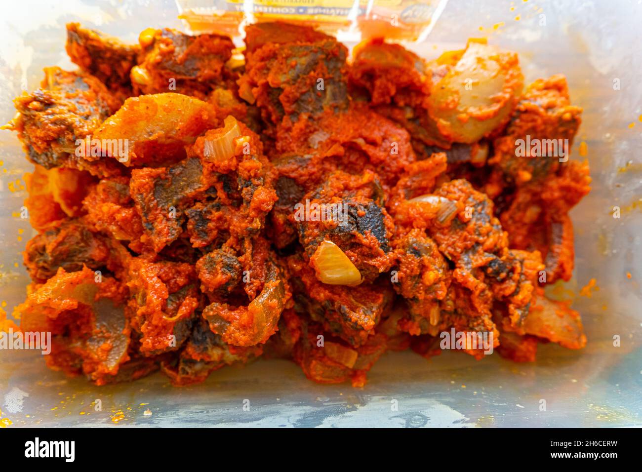 Nigerian African Pepper beef stew in container Stock Photo - Alamy