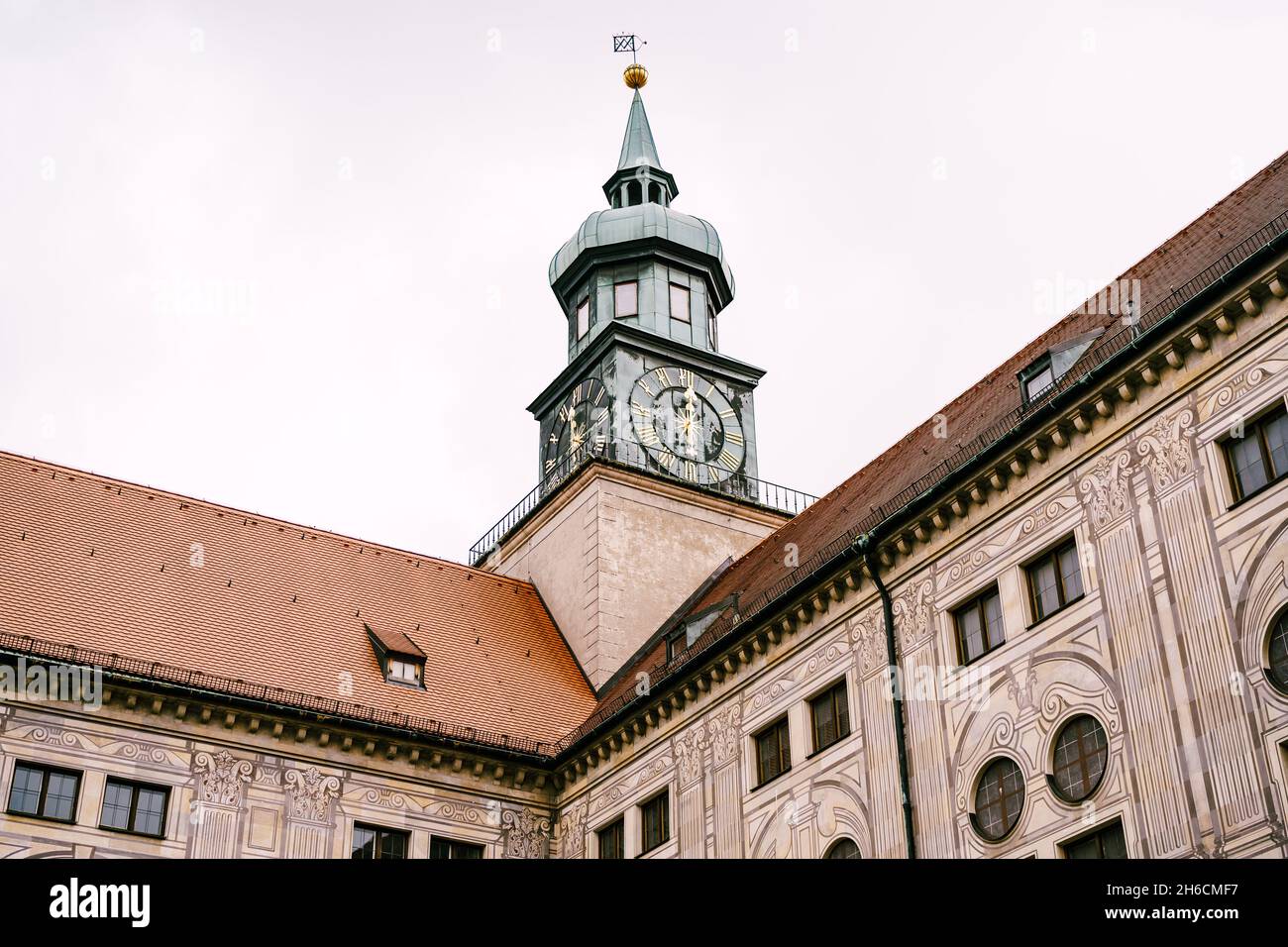 High spire of the Munich Residence tower with a clock on the facade ...