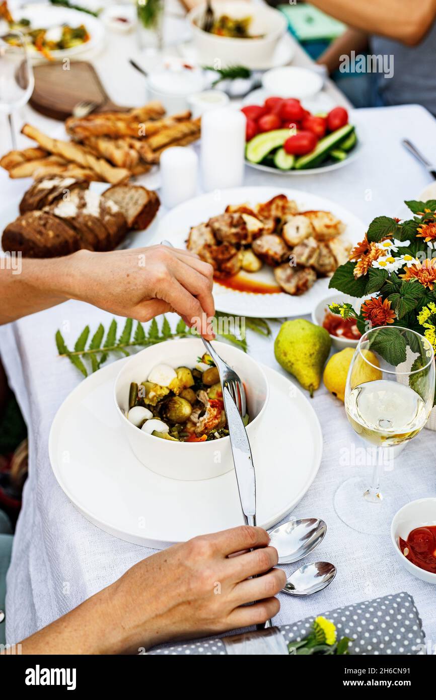 A festive family dinner or barbecue in the summer garden. Family ...