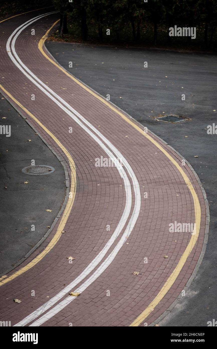 curved bike path through a park with trees. healthy lifestyle Stock ...