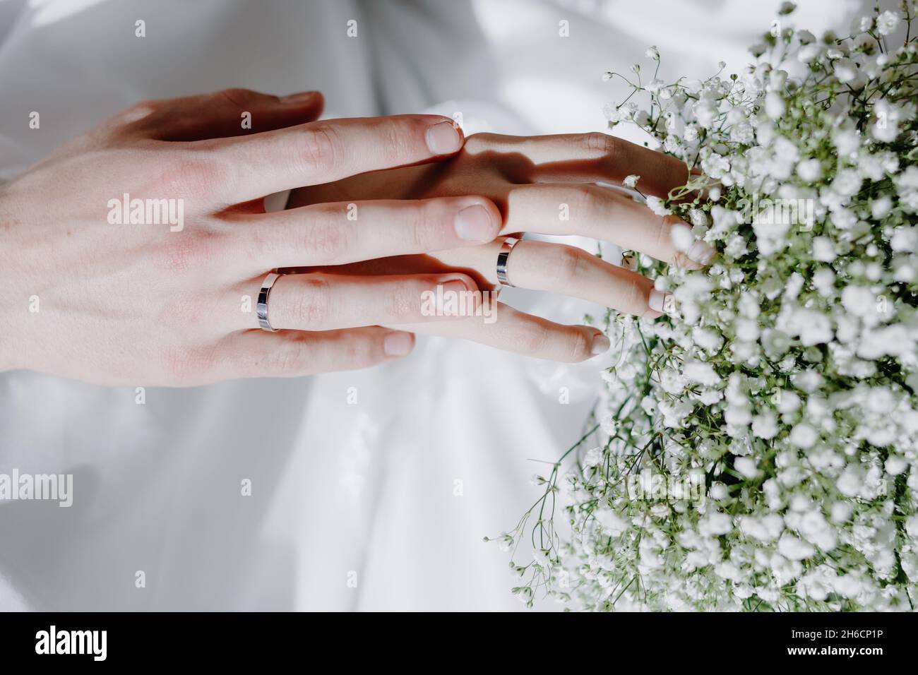 Wedding. Bride and groom holding hands Stock Photo - Alamy