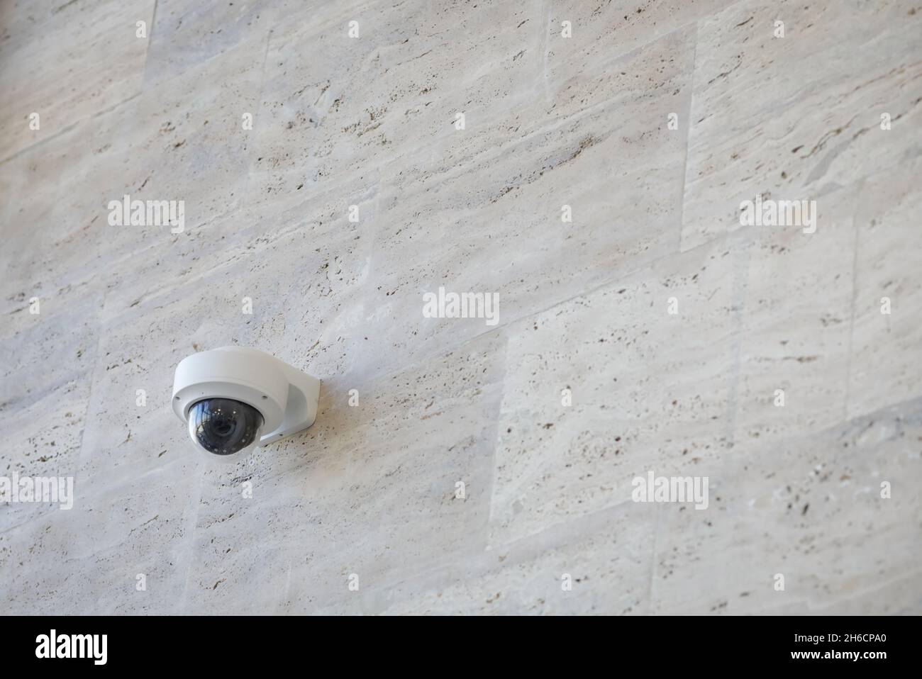Details with a CCTV camera on a wall inside a building Stock Photo - Alamy