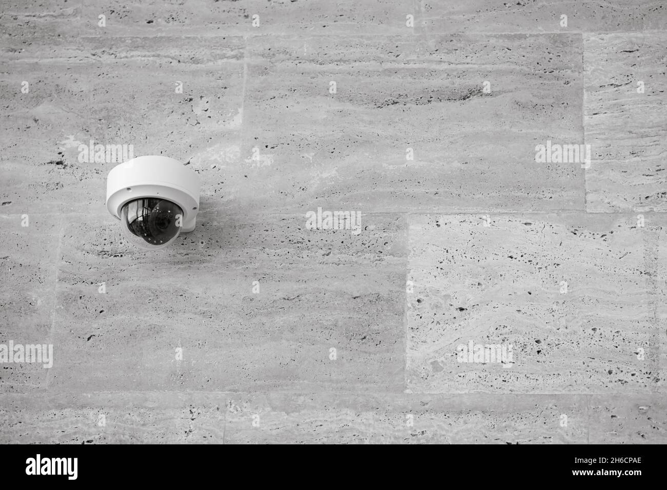 Details with a CCTV camera on a wall inside a building Stock Photo - Alamy