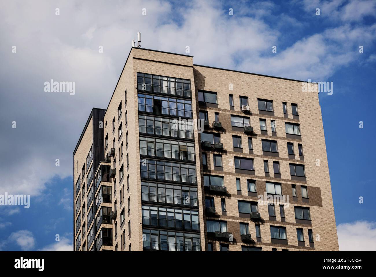 new brick apartment building with blue sky background. european ...