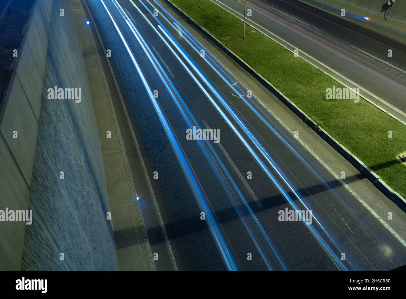 Light trails on the underpass road at night. Traffic or highway ...