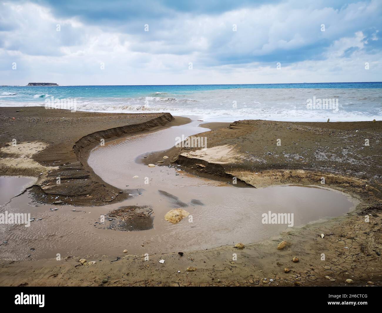 Small stream of water flowing into Mediterranean Sea. White River Beach ...