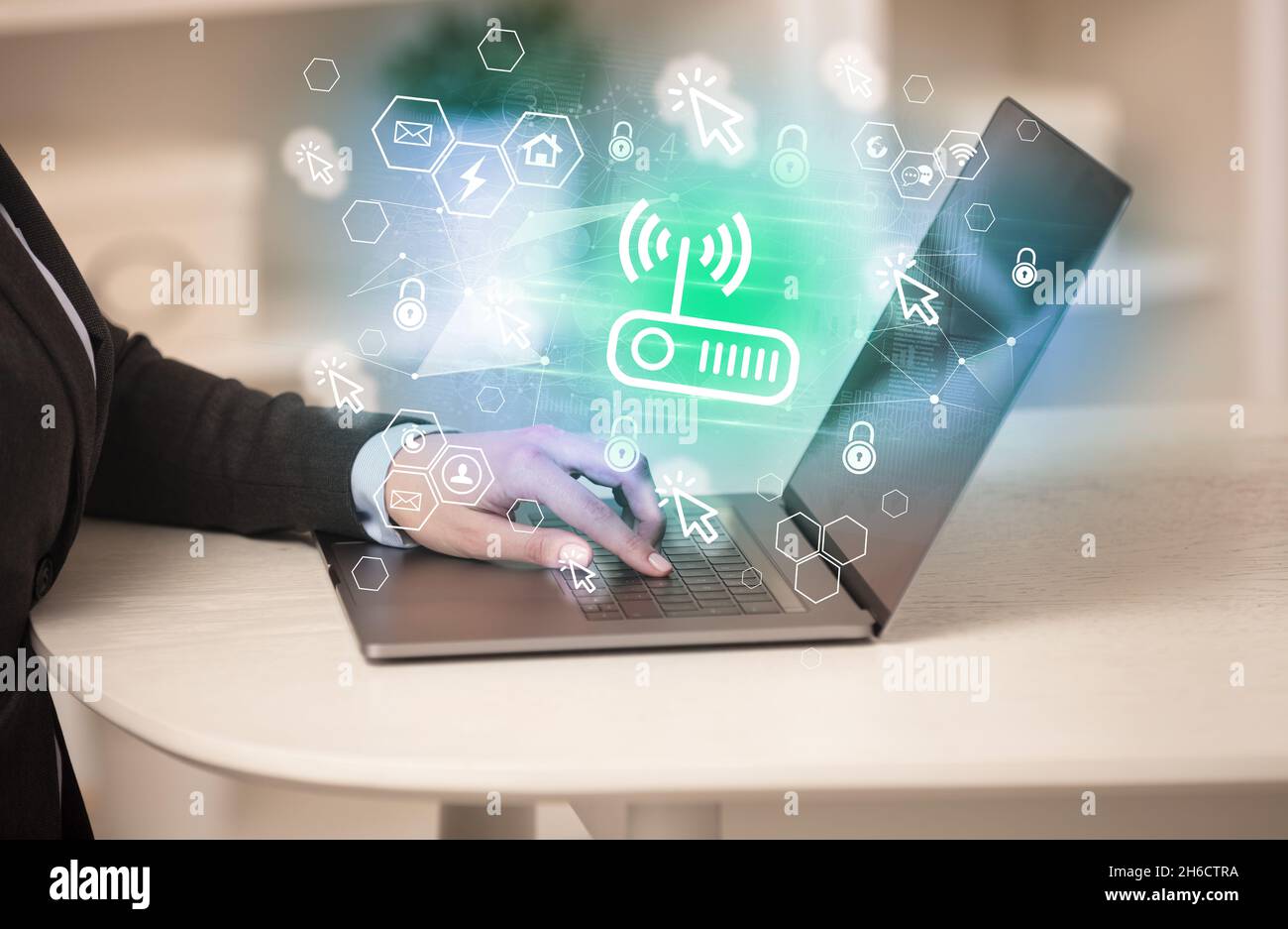 Hands working on laptop with digital icons Stock Photo - Alamy