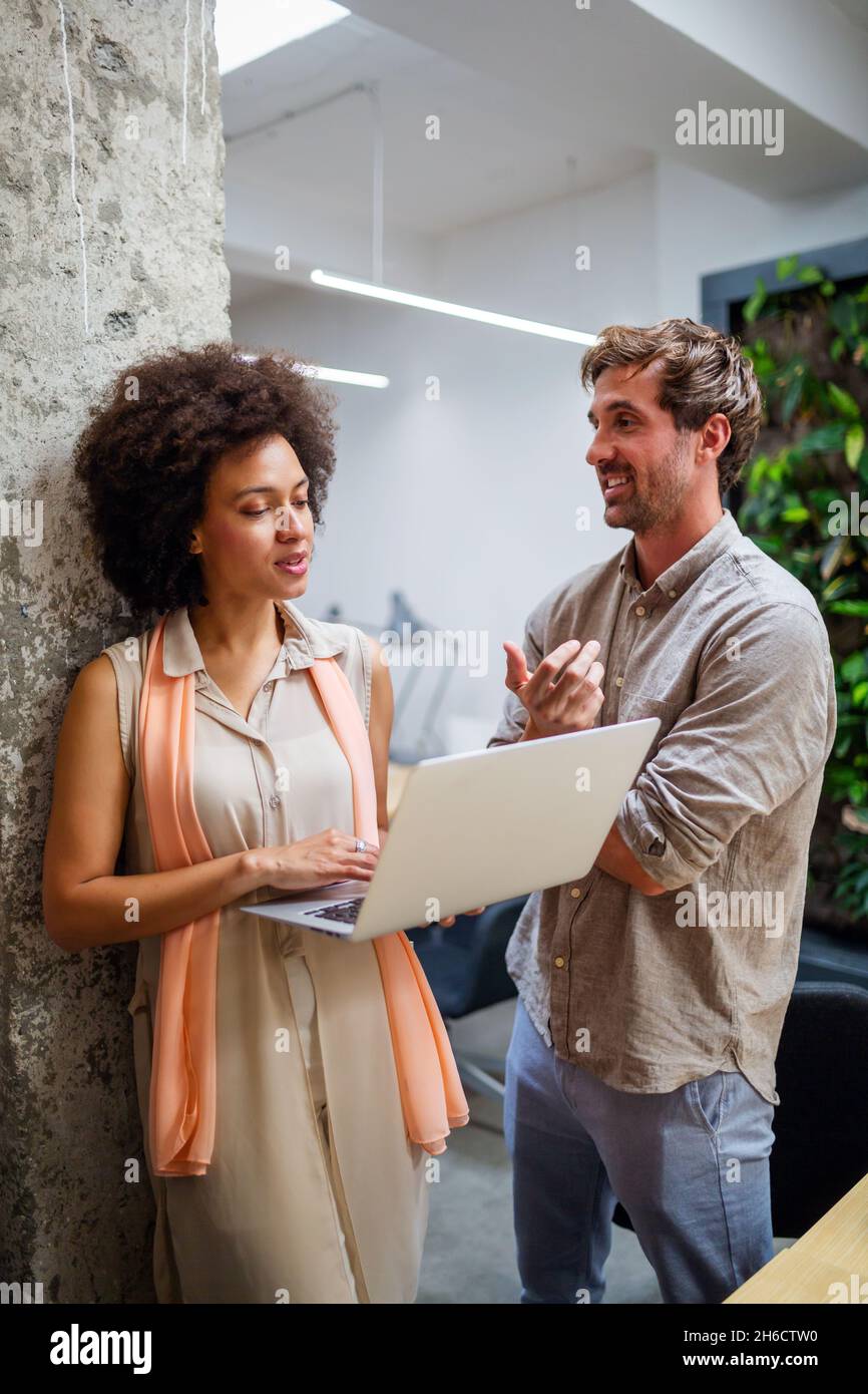 Happy business people having fun and chatting at workplace office ...