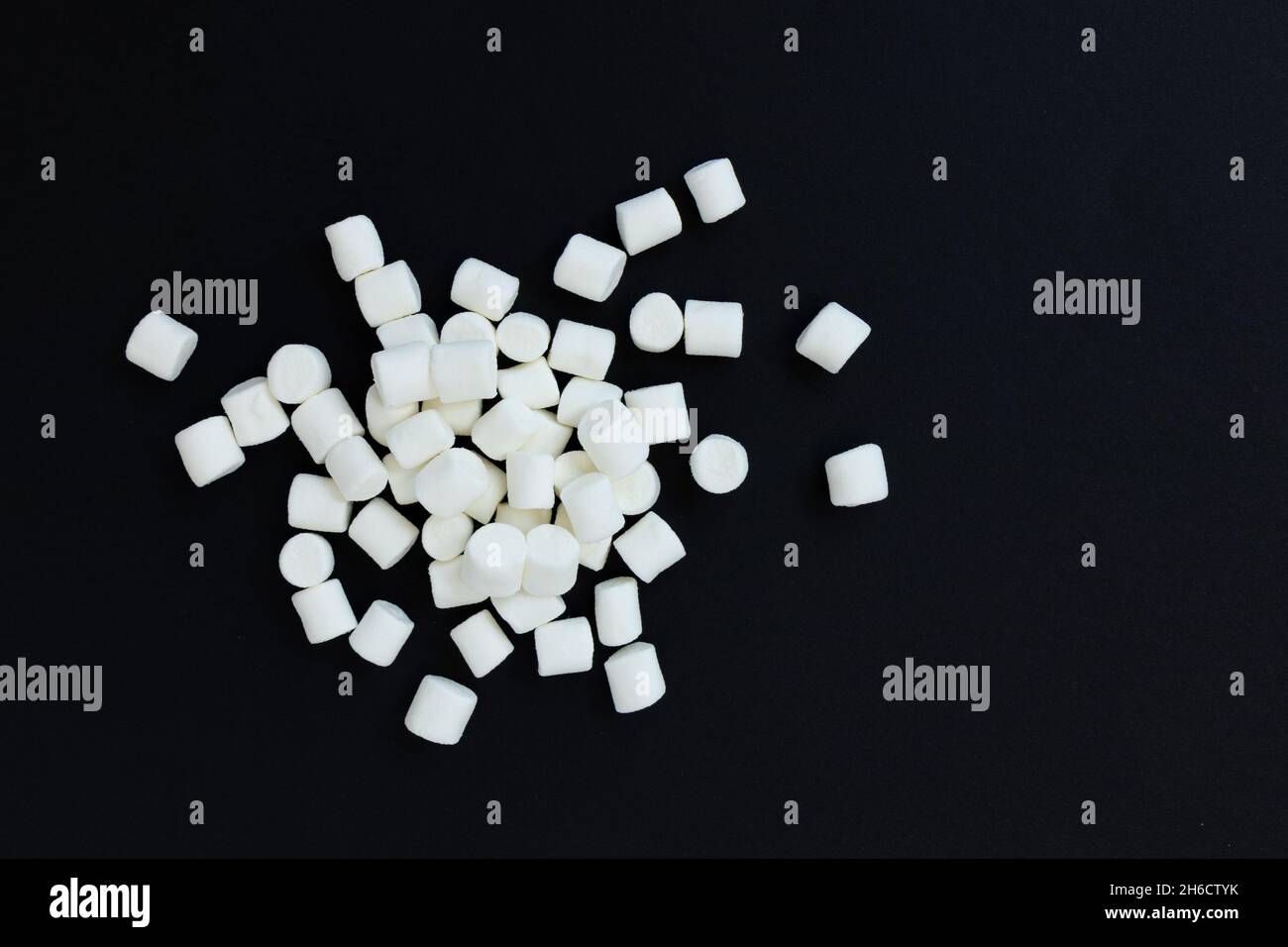 pile of marshmallows on black background, flat lay or top view ...