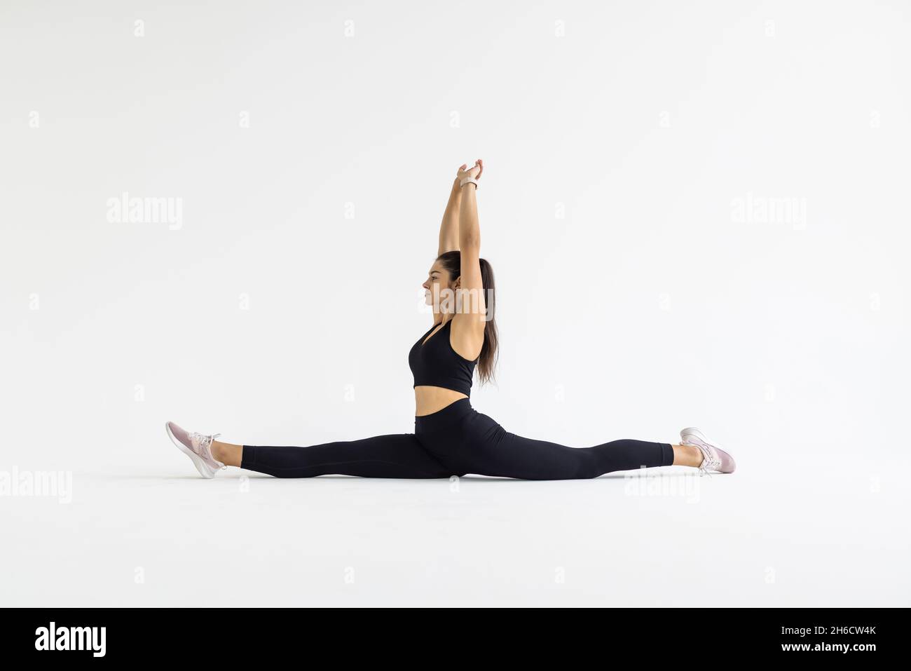 Fitness woman leg split on white background. Yoga, fitness and training ...