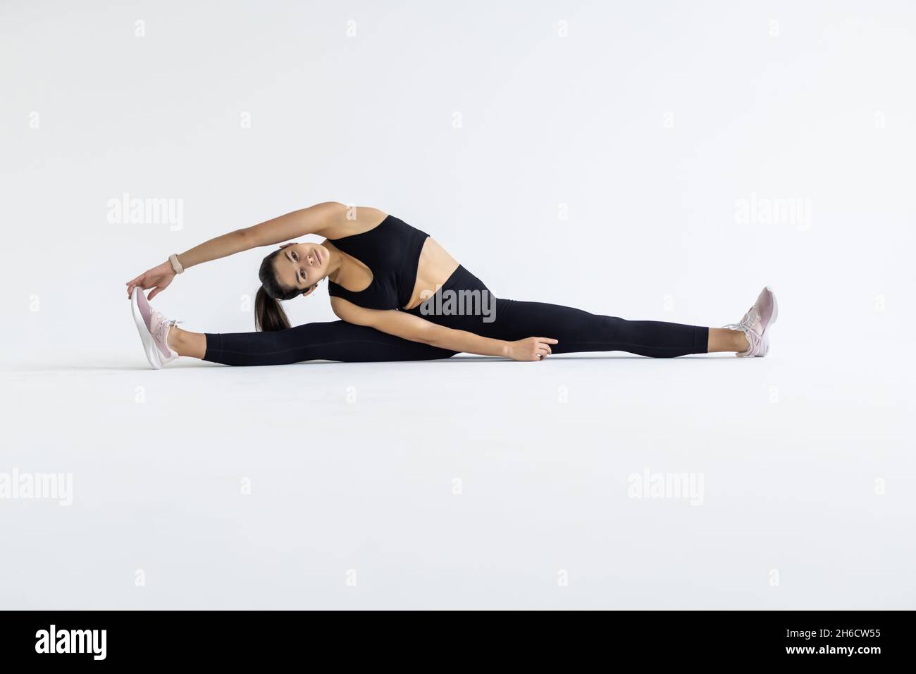 athletic girl doing hand exercises sitting on the splits Stock Photo ...