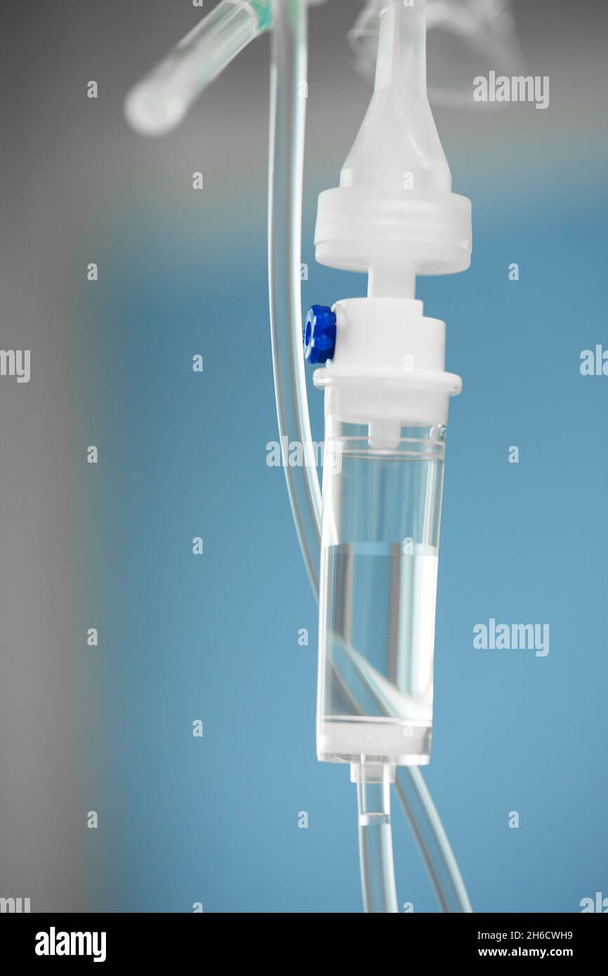 Close-up of IV tube. Action. Dropper with drug slowly dripping down ...
