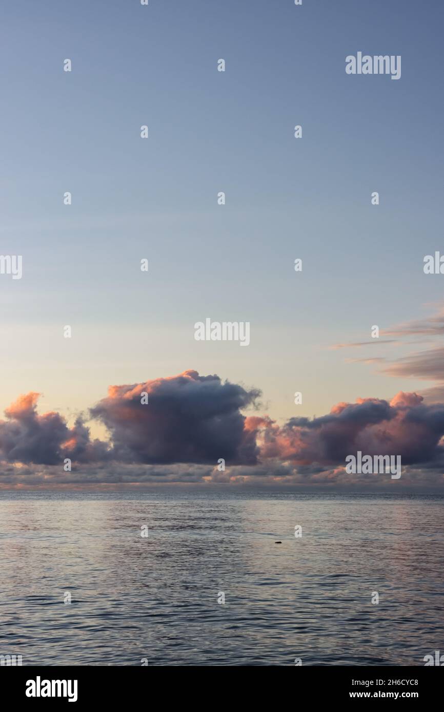 horizon line portrait photo with purplish-black clouds Stock Photo - Alamy