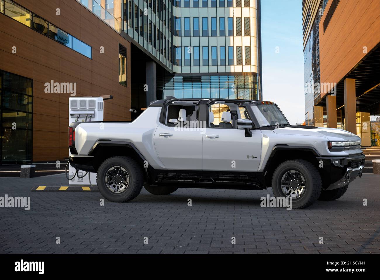GMC HUMMER EV Pickup, All-Electric Truck on fast charging station Stock ...
