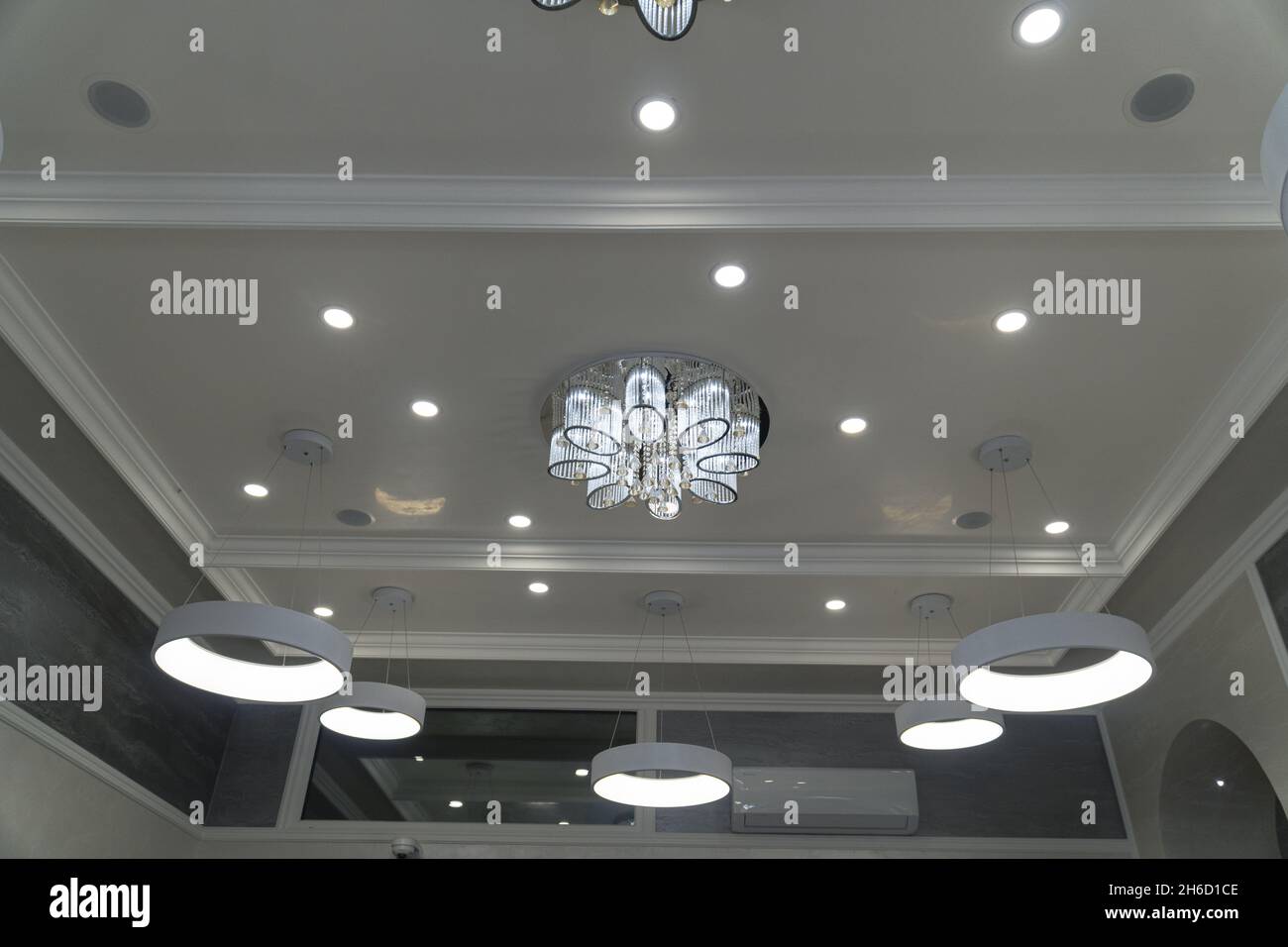 Low angle shot of saloon light fixtures on white paint and chrome ...