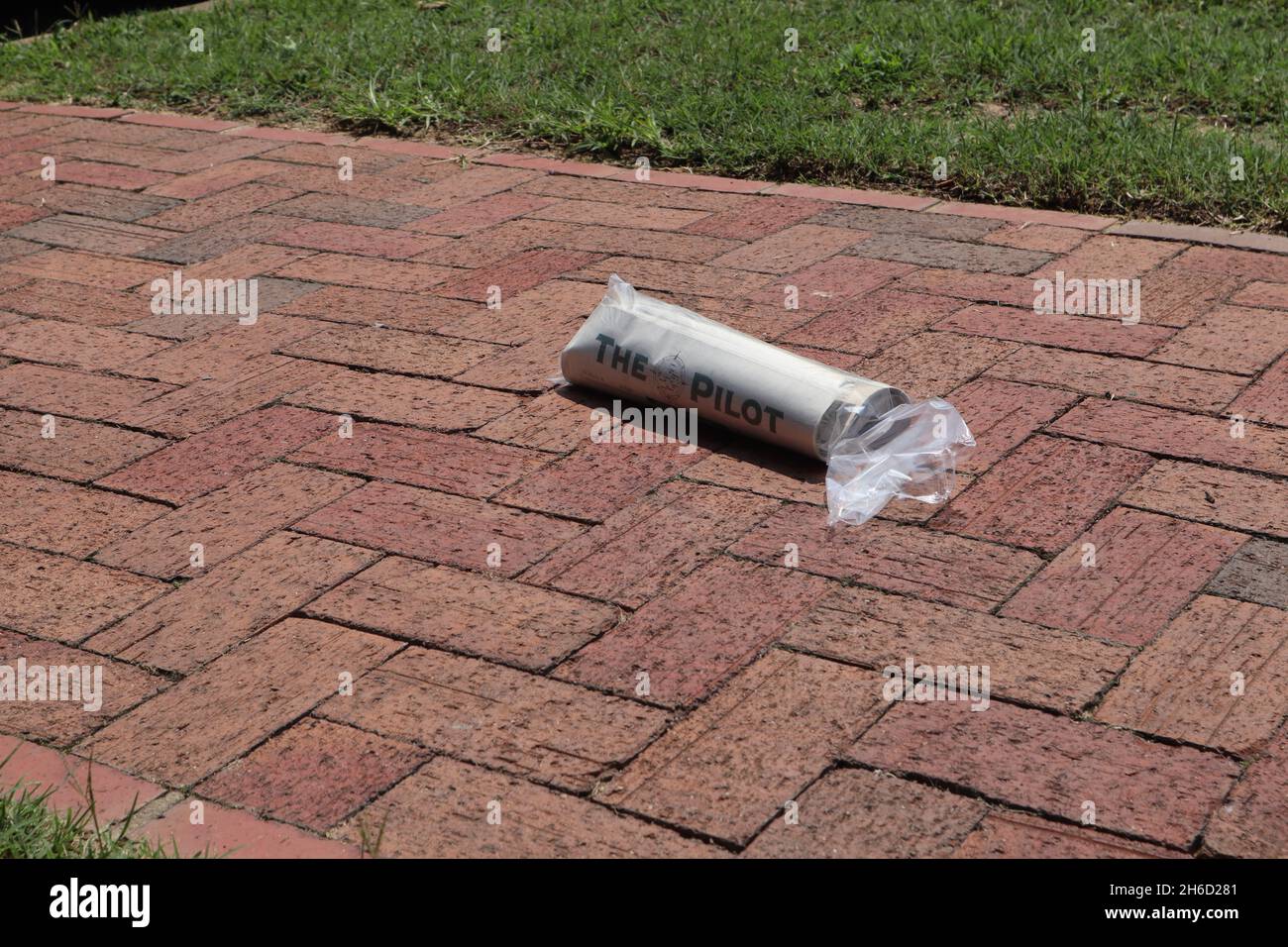 Newspaper on a plasti delivered on a brick driveway Stock Photo - Alamy